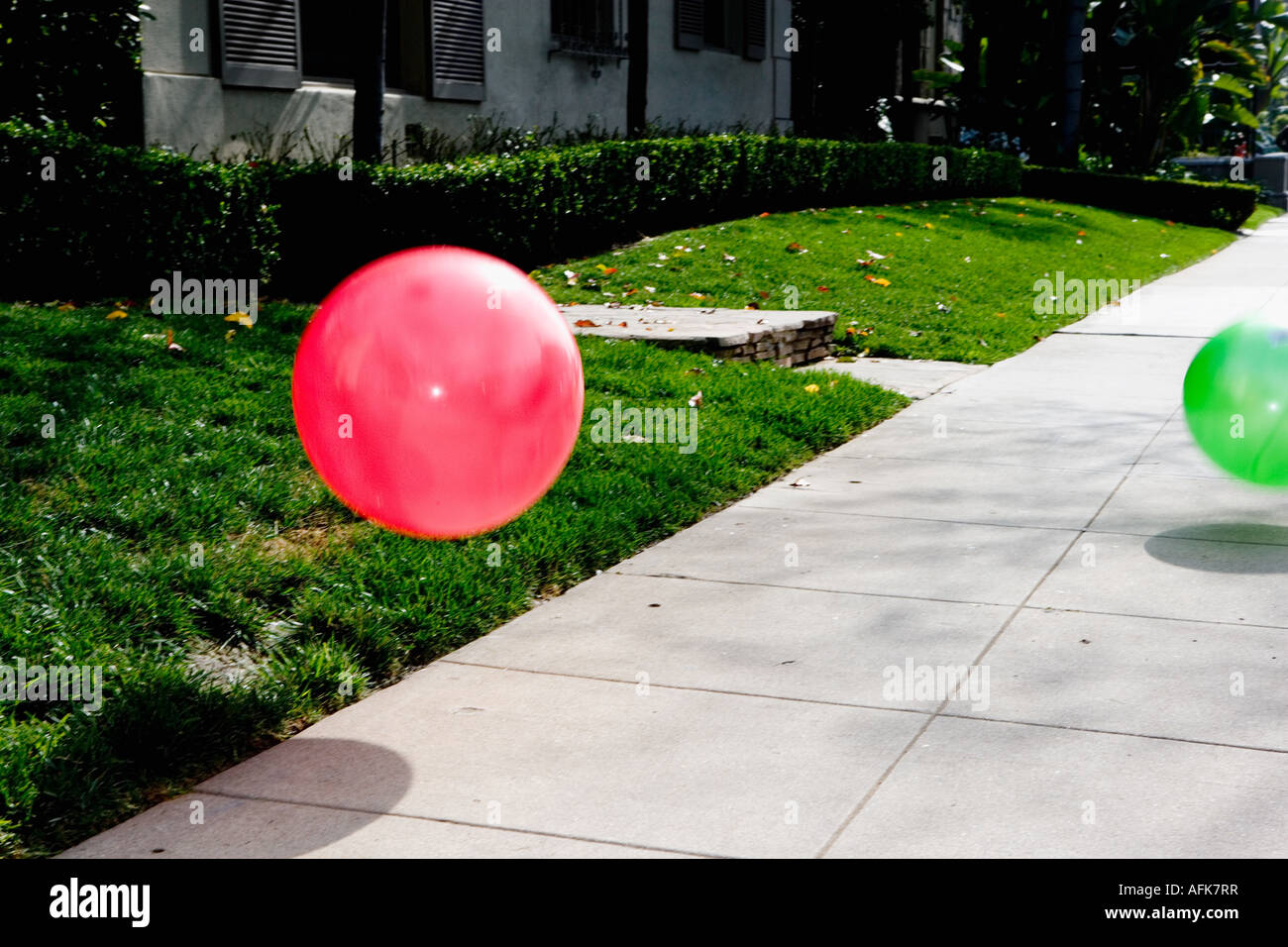 Two balloons flying over a walkway Stock Photo - Alamy