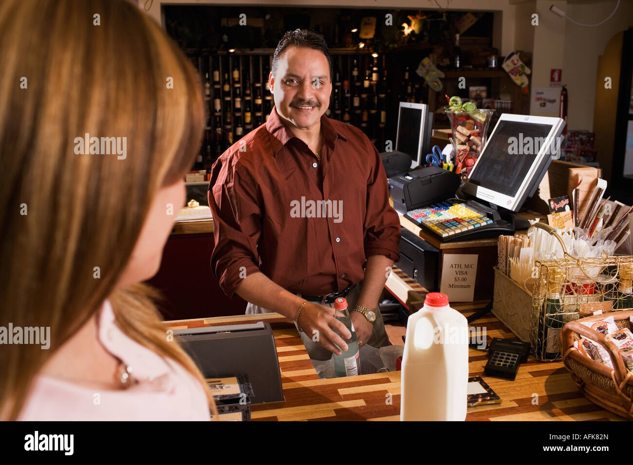 Business owner checking customers groceries Stock Photo - Alamy