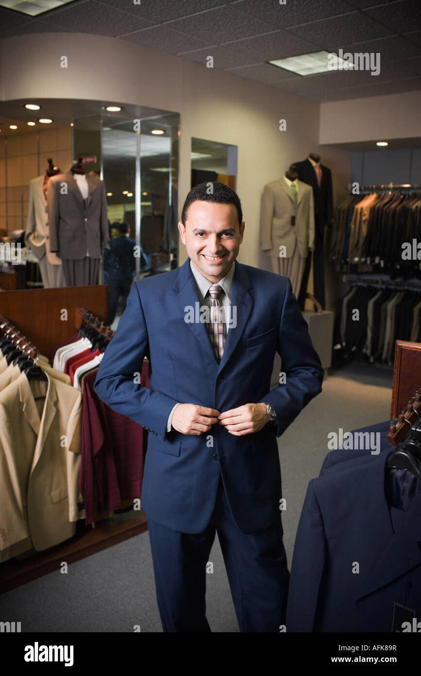 Sales associate in menswear store in mall Stock Photo - Alamy