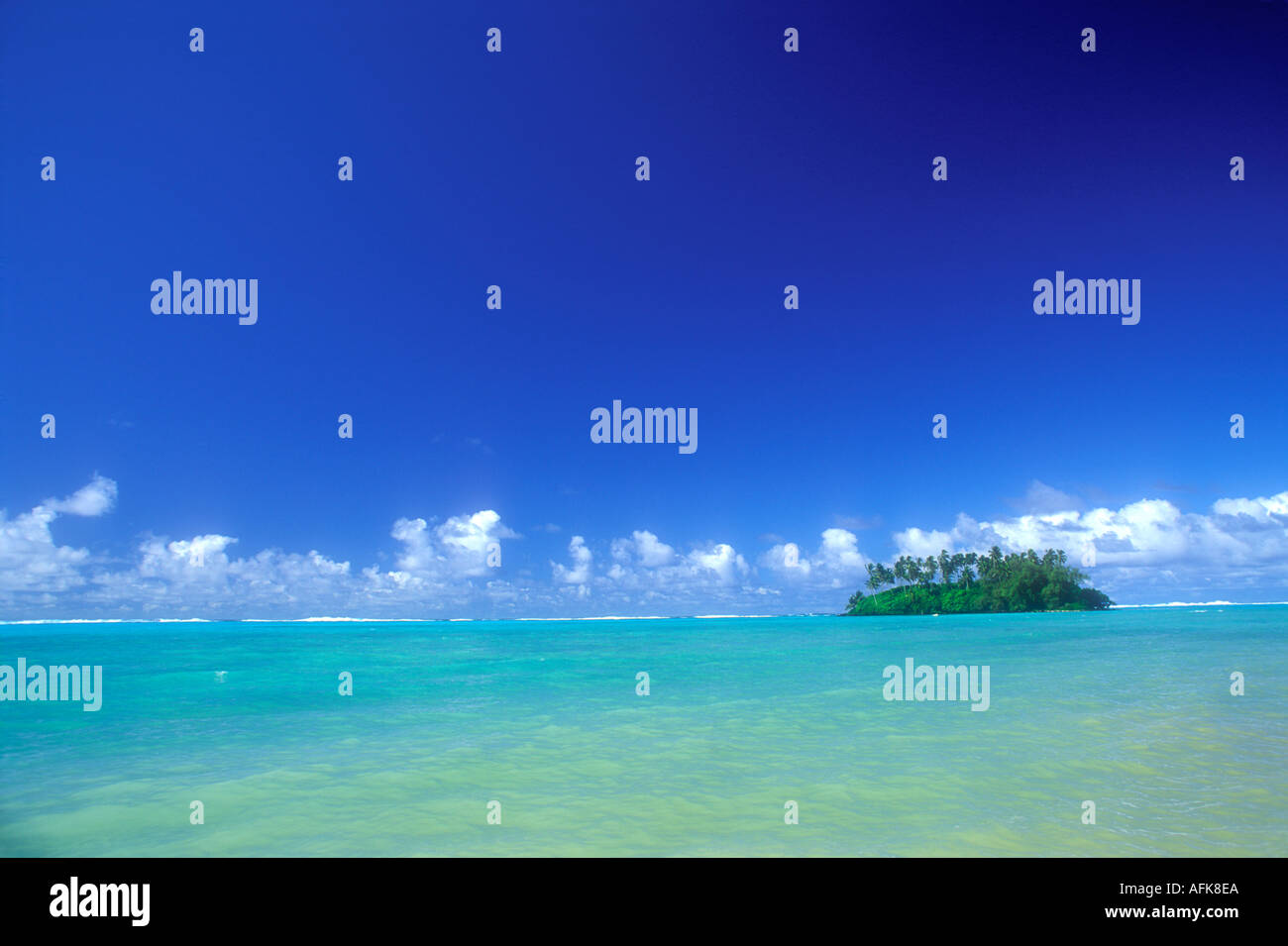 Small tropical island on horizon in the Cook Islands Polynesia South ...