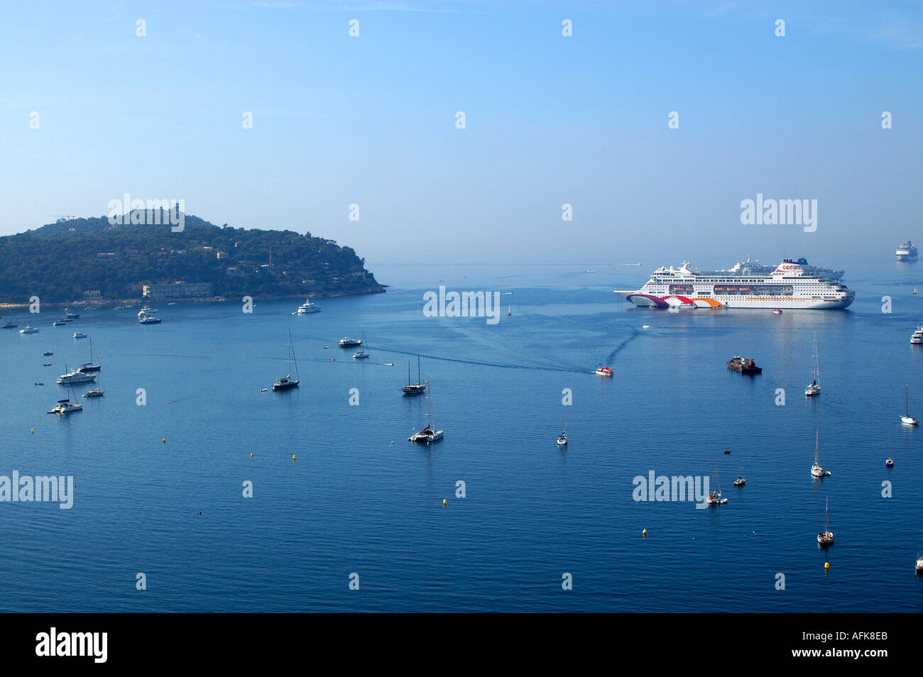Horizontal image of an ocean liner near the Monaco coast line with ...