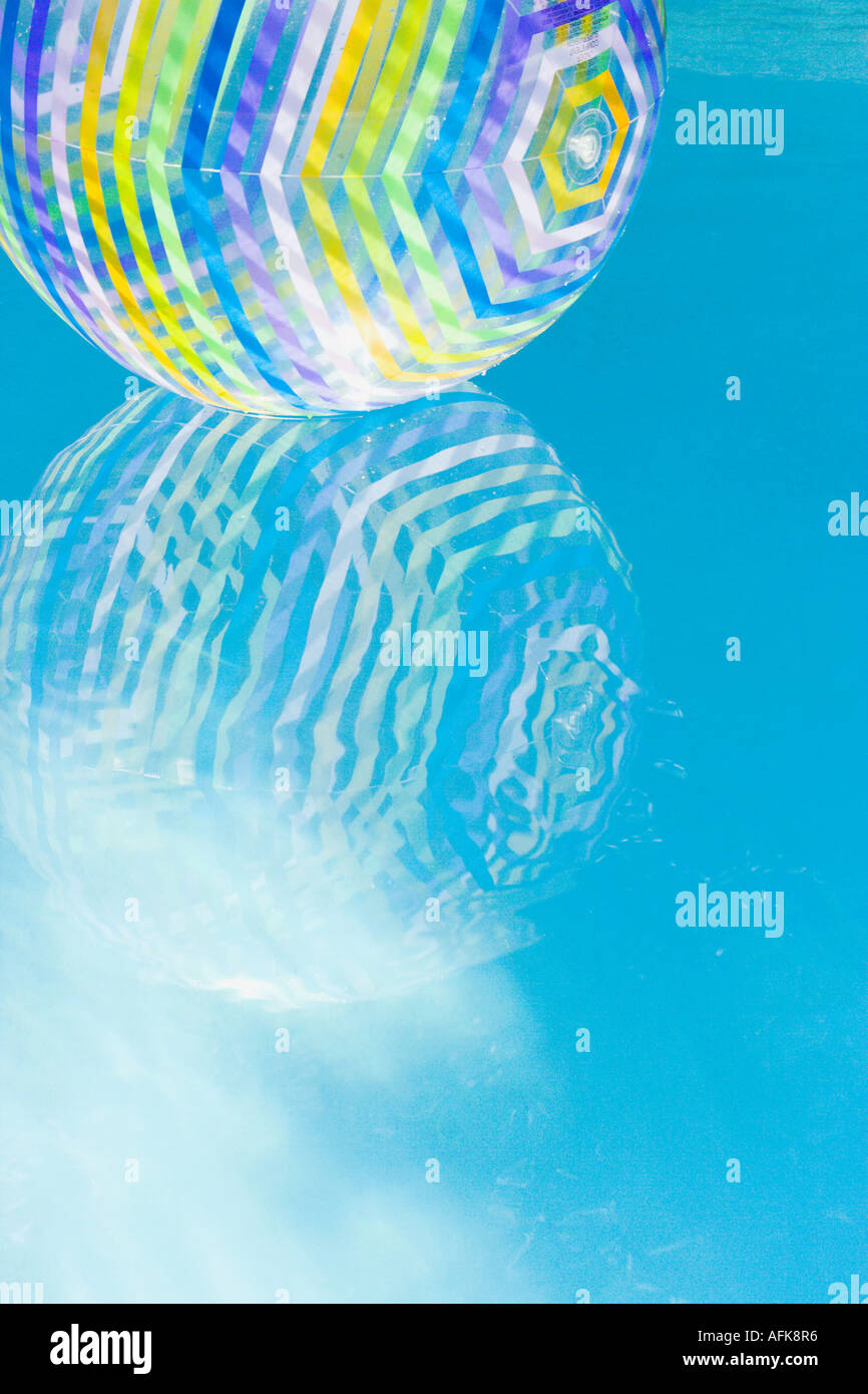 Beach ball reflected in swimming pool water Stock Photo - Alamy