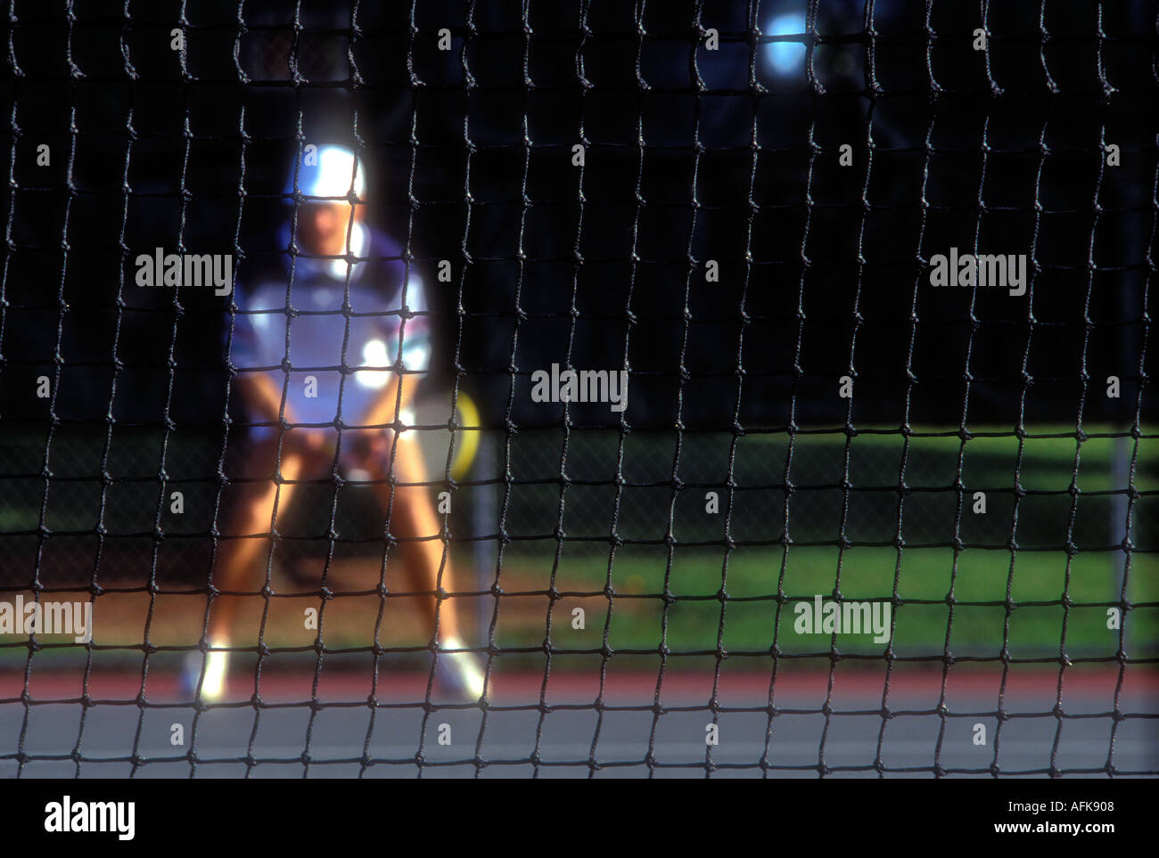 Tennis player behind tennis net Model Released Image Stock Photo - Alamy