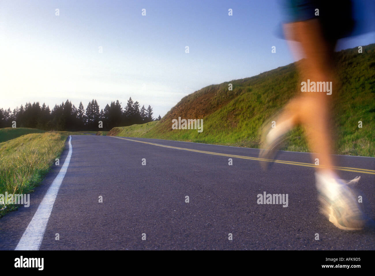 Road and blurred legs of running man Model Released Photo Stock Photo ...