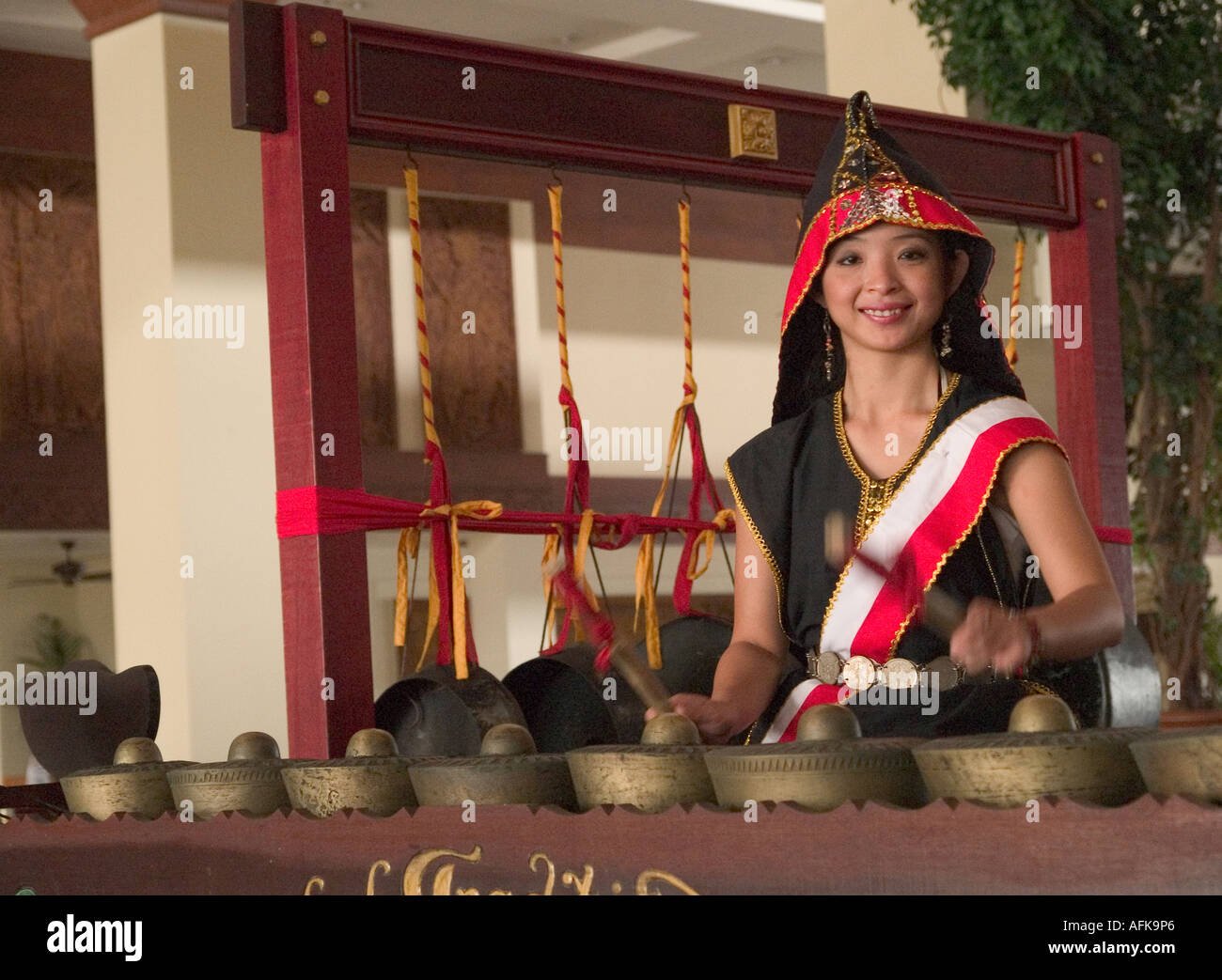 MALAYSIA, SABAH, KOTA KINABALU, FEMALE MUSICIAN IN TRADITIONAL DRESS ...