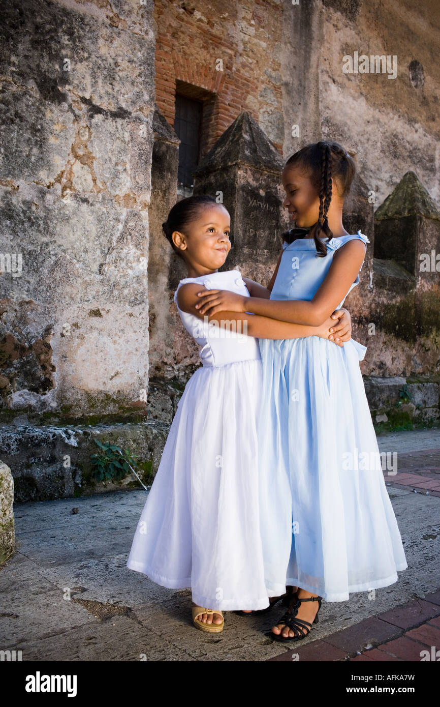 Side profile of two girls smiling and hugging Stock Photo - Alamy