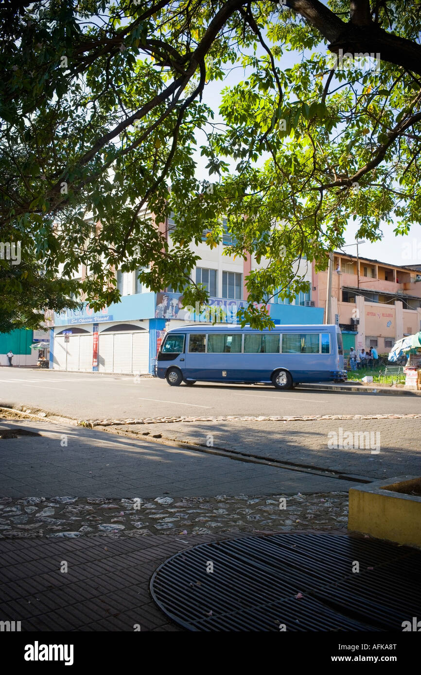 Bus parked in front of a building Stock Photo - Alamy