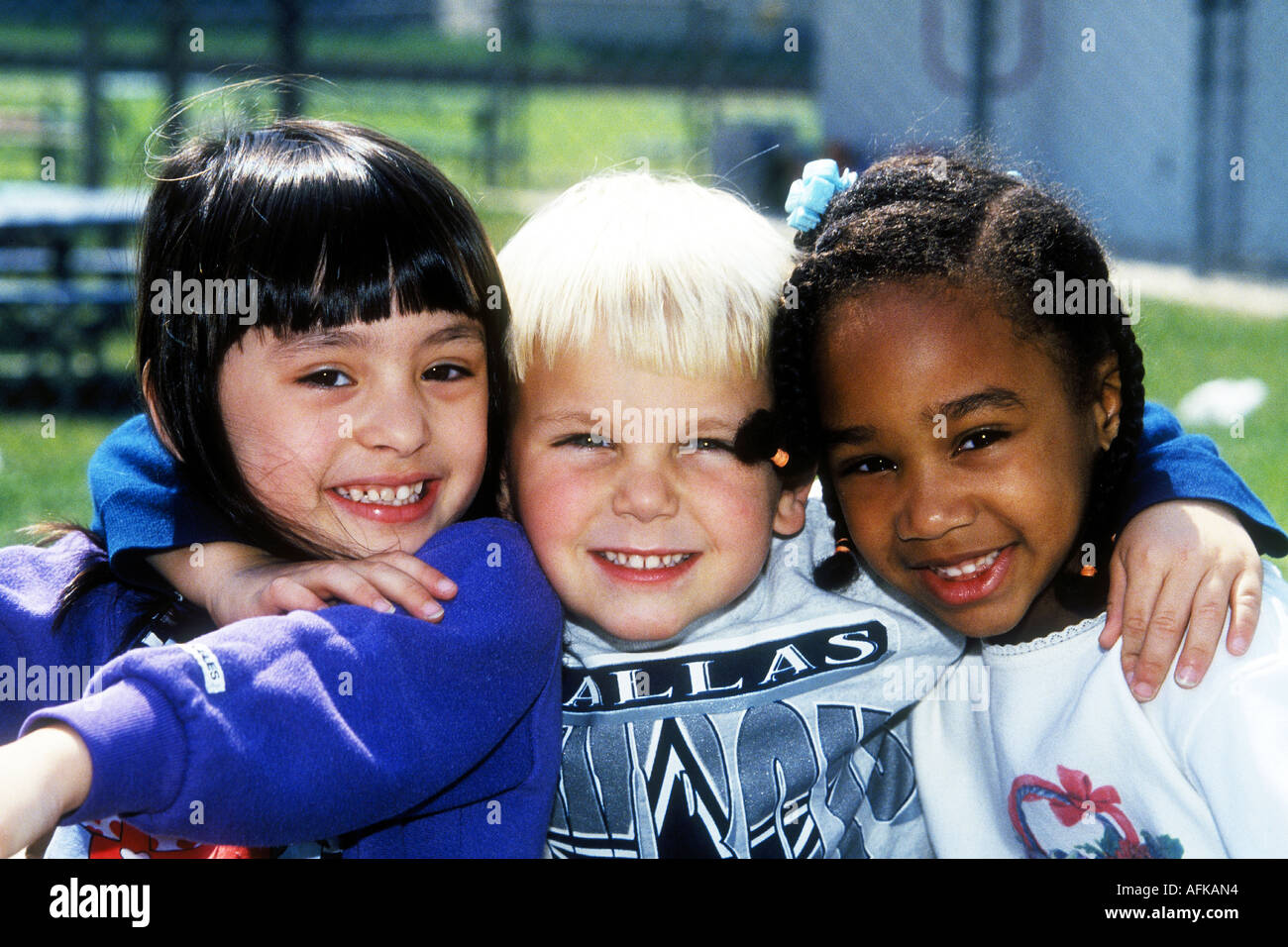Multicultural preschoolers show togetherness at the playground. USA ...