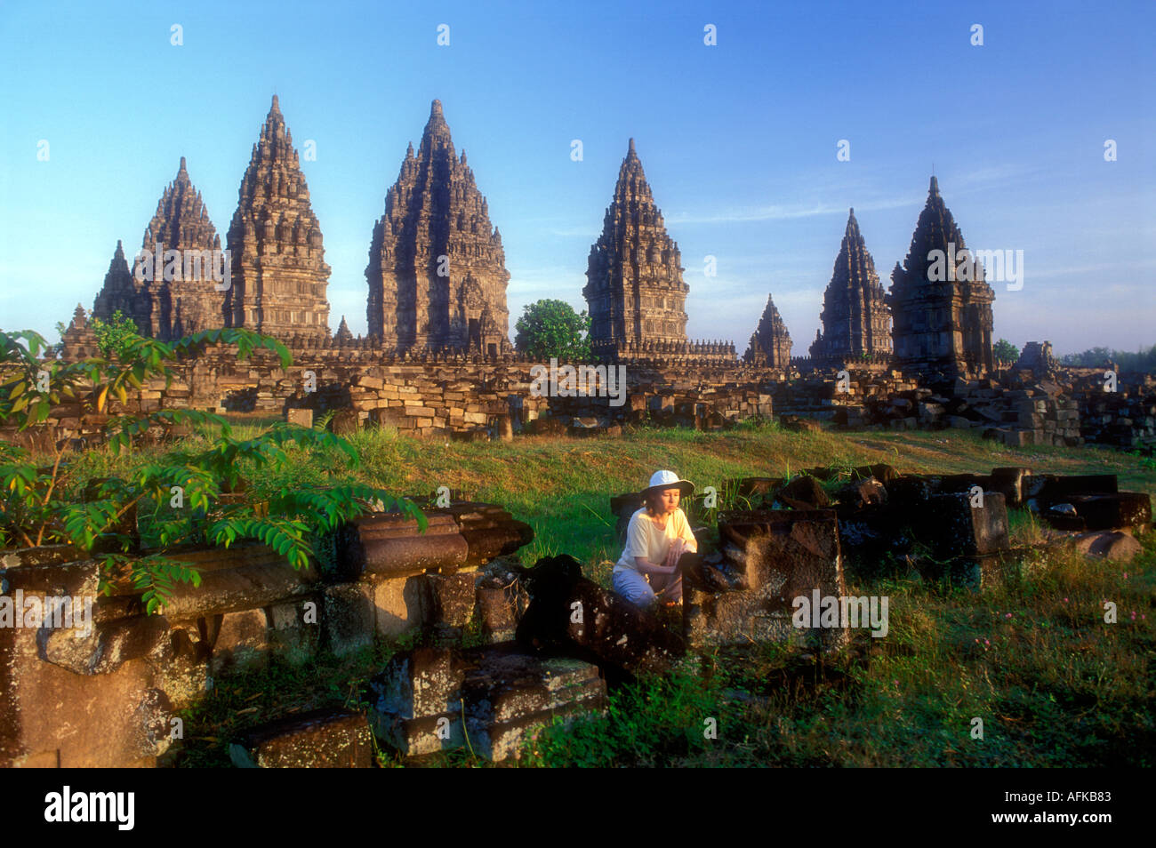 Woman examining stone carvings at the Prambanan Hindu temple complex in ...