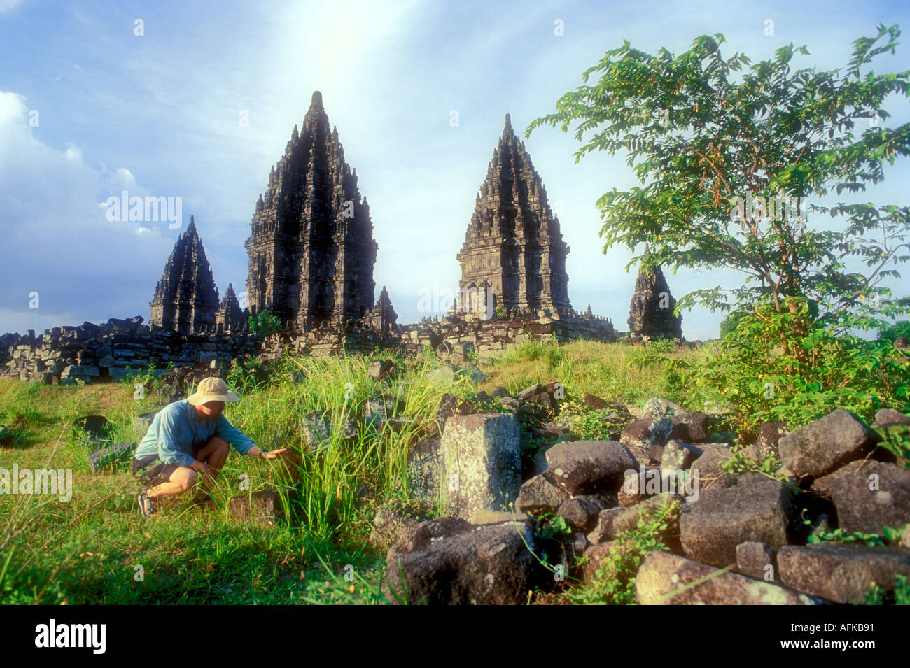 Man looking at stone carvings at the Prambanan Hindu temple complex in ...