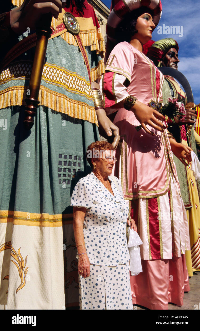 A woman is dwarfed by towering gegants (giants) as part Barcelona's ...