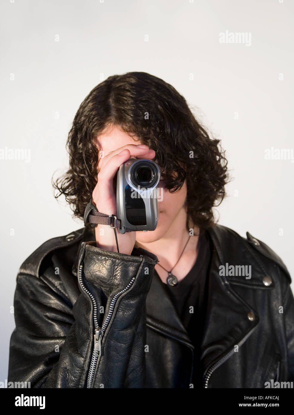 Young man using video camera Stock Photo - Alamy