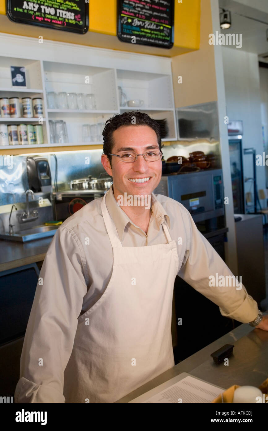 Male store clerk standing in a coffee shop Stock Photo - Alamy