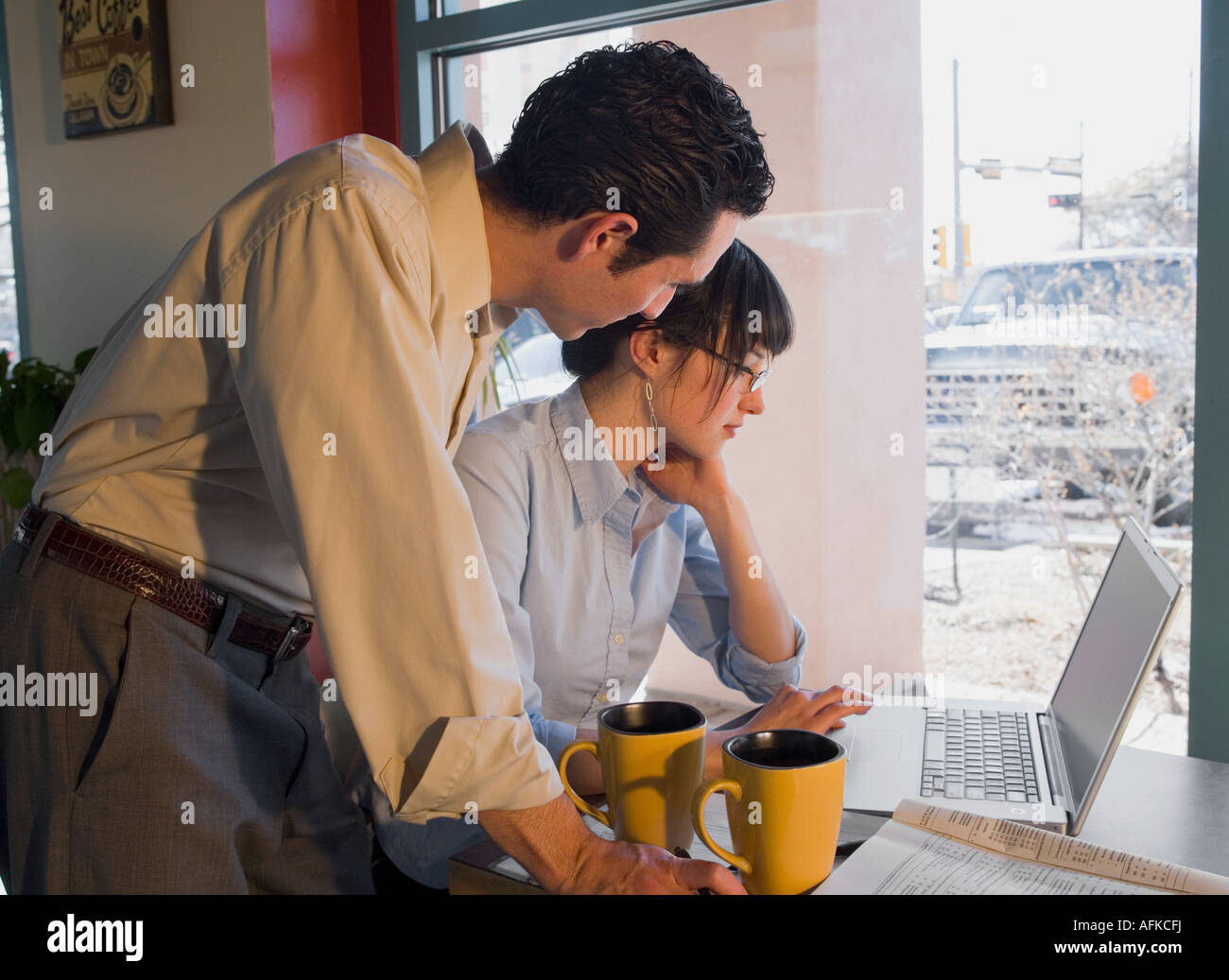 Side profile of a businesswoman and a businessman working together on a ...