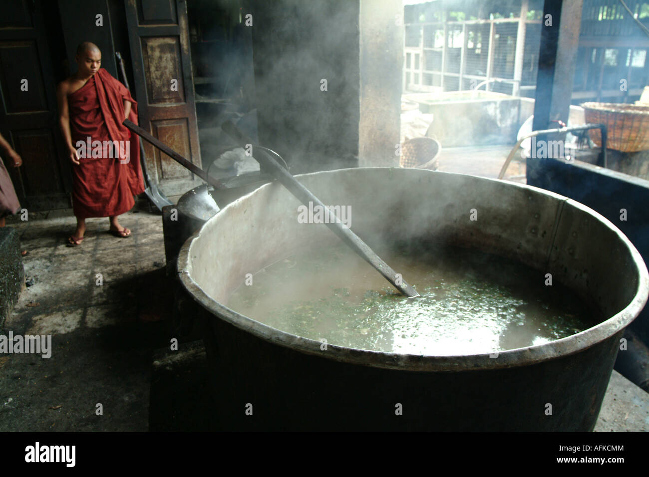Food cooking in an enormous pot in the Mahagandayon Buddhist monastery ...