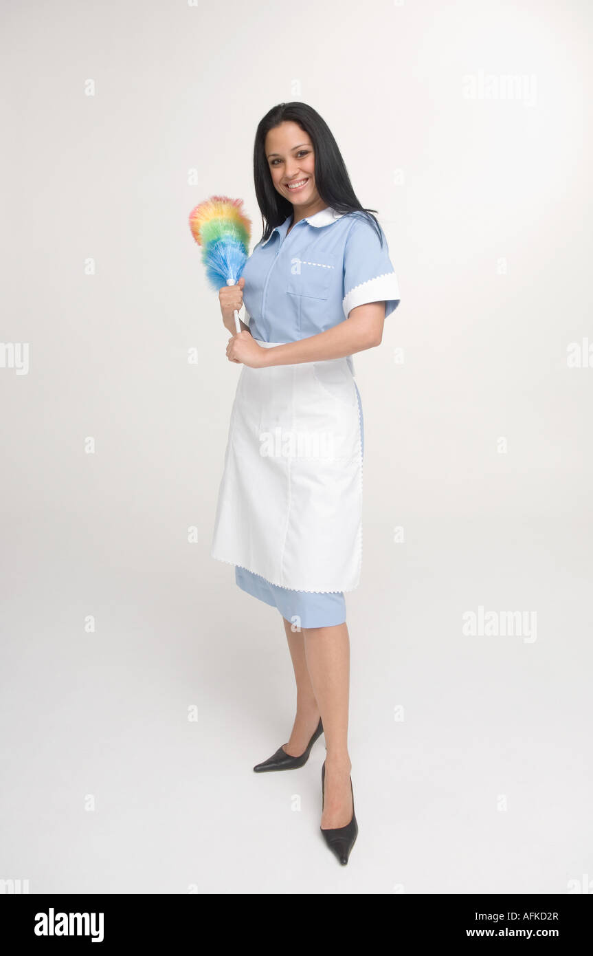 Maid holding feather duster Stock Photo - Alamy