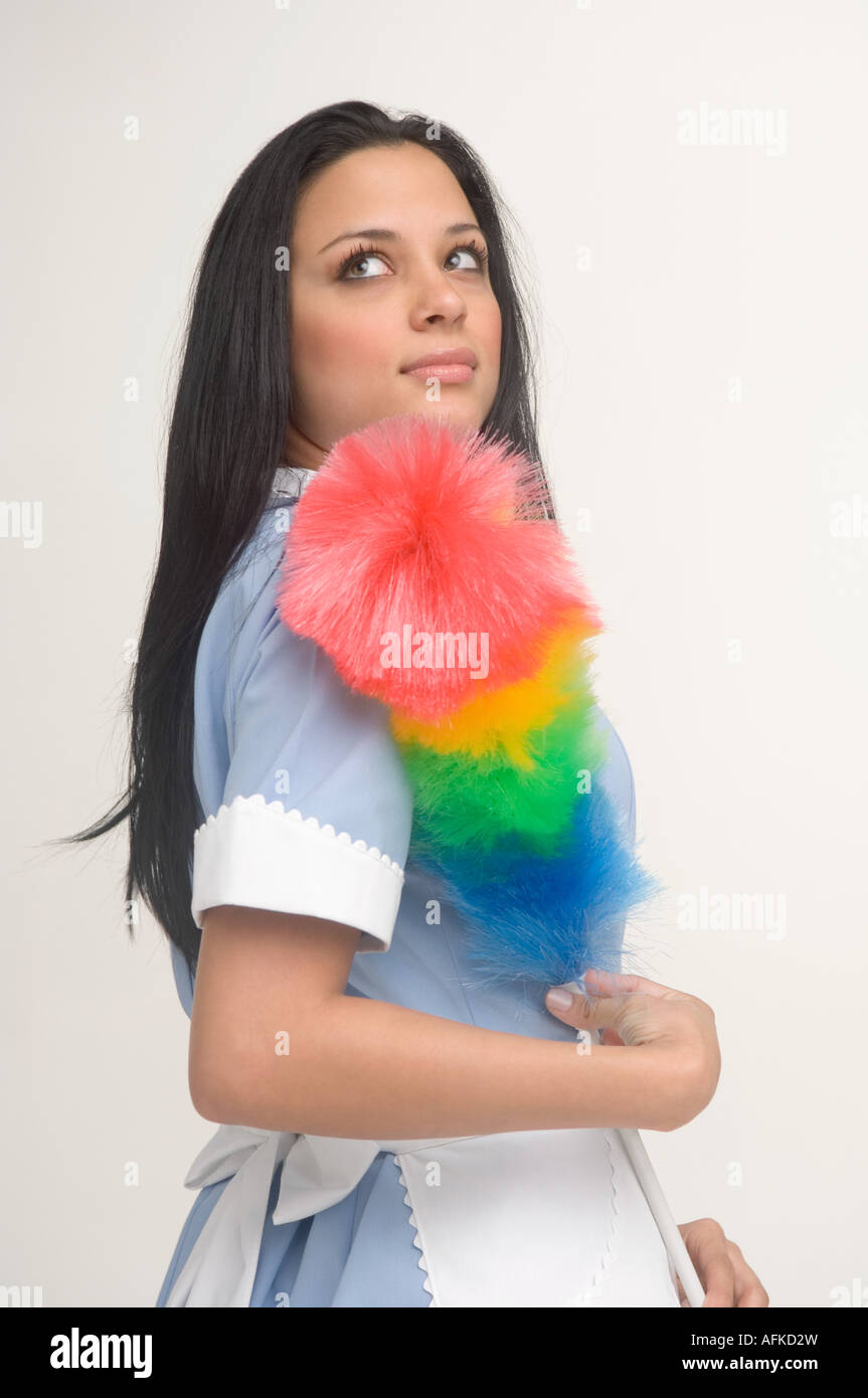 Maid holding feather duster Stock Photo - Alamy