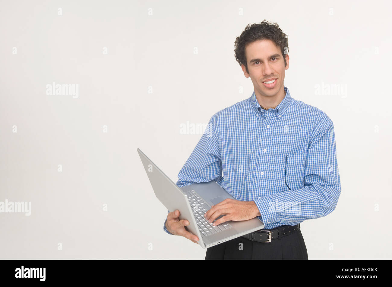 Young man holding laptop Stock Photo - Alamy