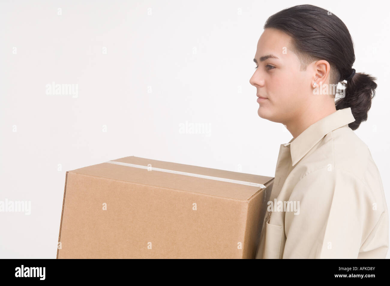 Delivery man carrying large box Stock Photo - Alamy