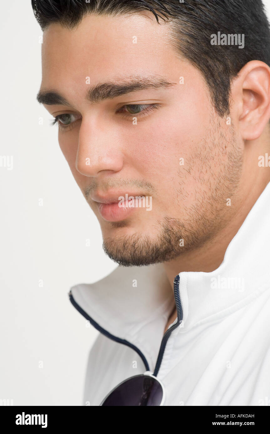 Portrait of young man looking down Stock Photo - Alamy