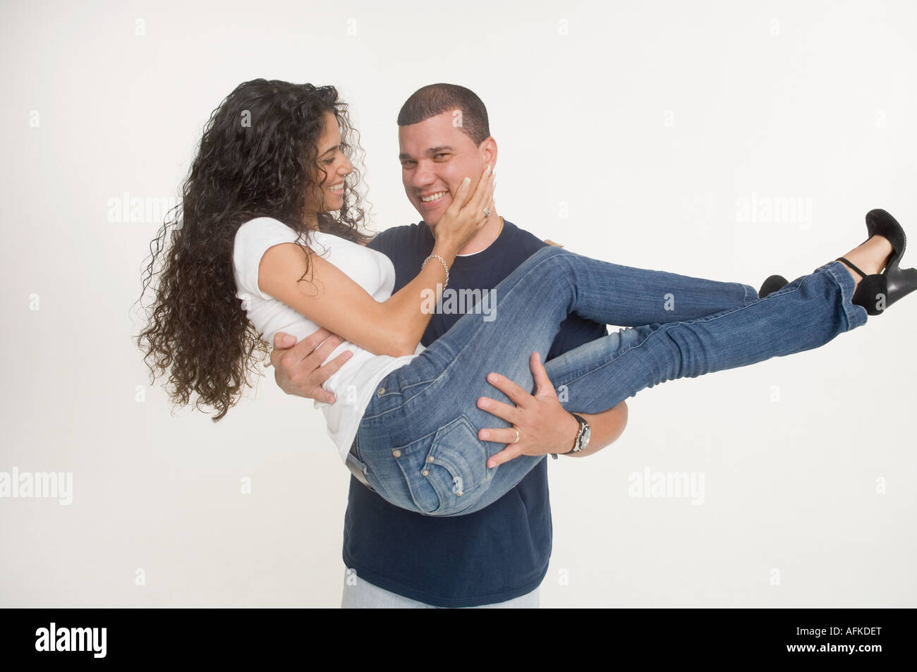 Young man carrying fiancee Stock Photo - Alamy
