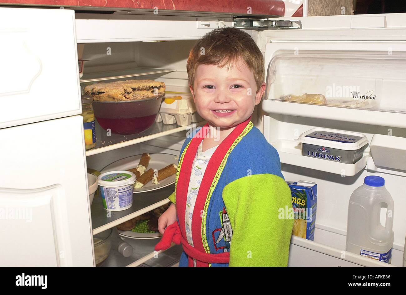 What's for supper child portrait of a child helping himself from the ...