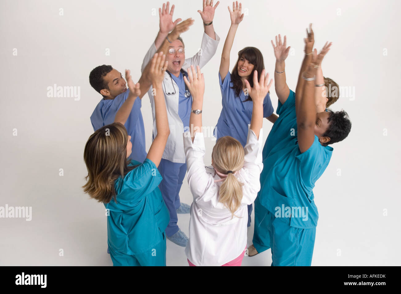 Group portrait of nurses and doctors cheering in circle Stock Photo - Alamy