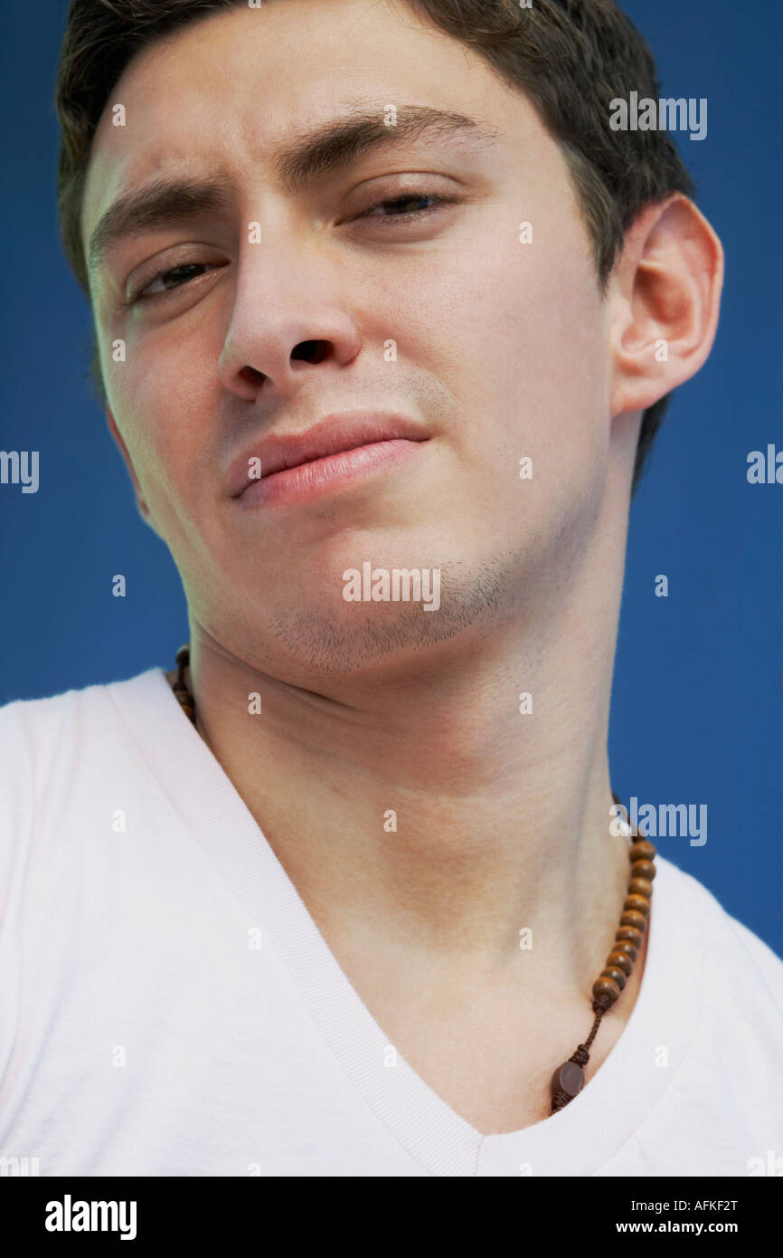 Young man squinting Stock Photo - Alamy
