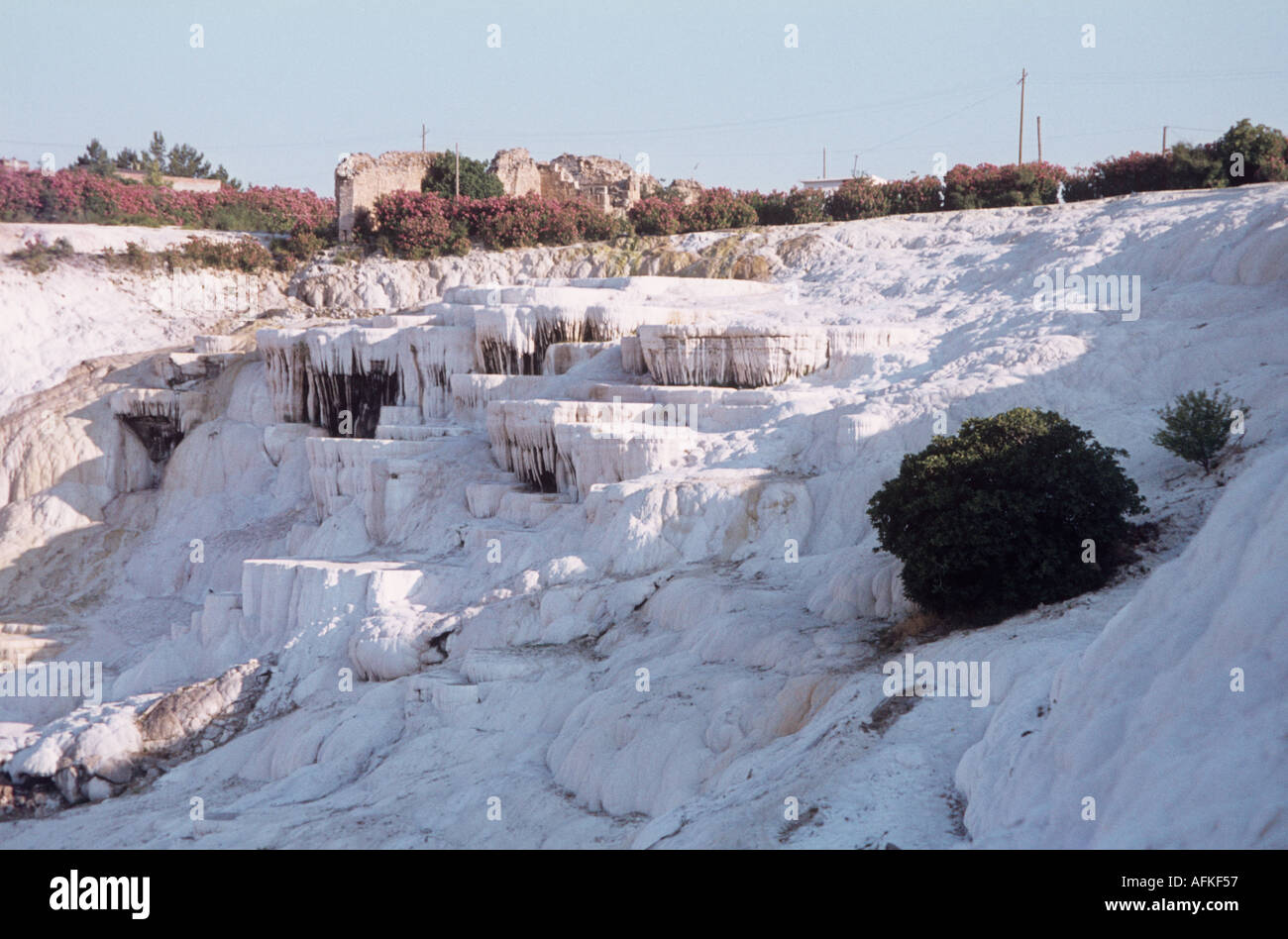 The white petrified cascades made by hot springs at Pamukkale or ...