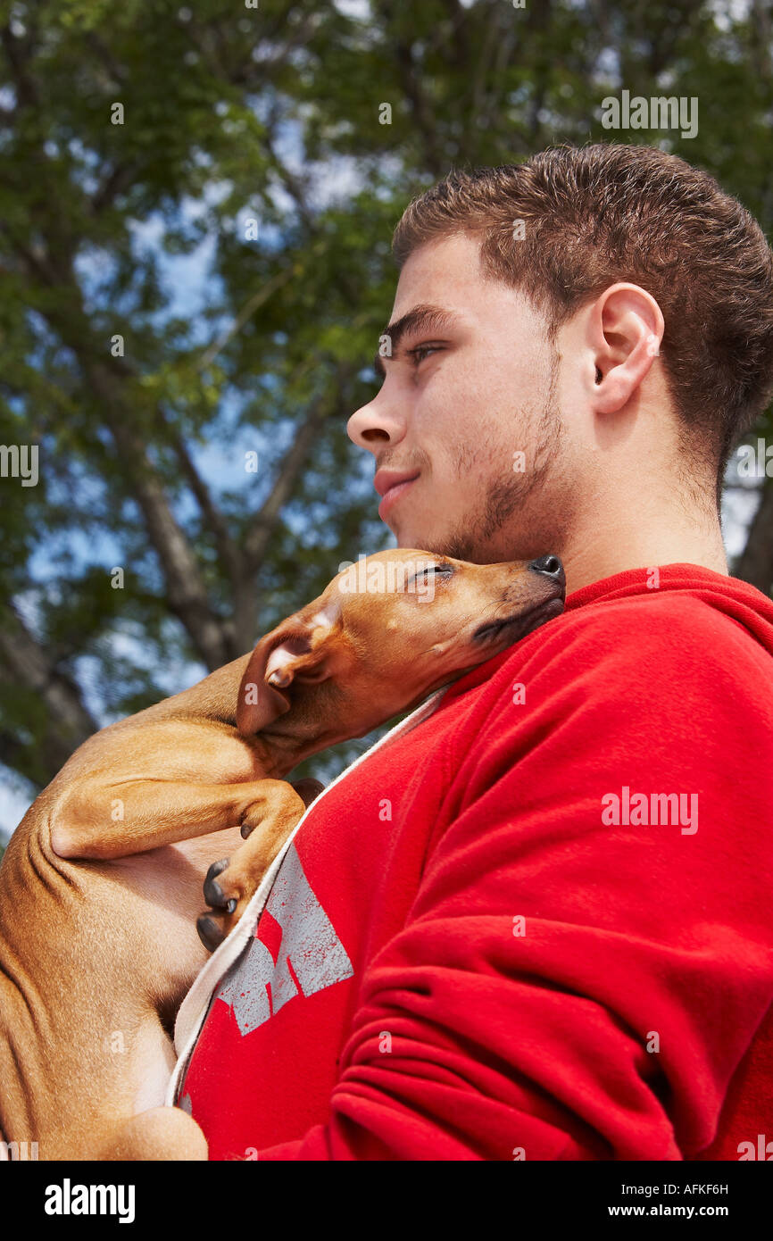 Side profile of a young man with a dog Stock Photo - Alamy