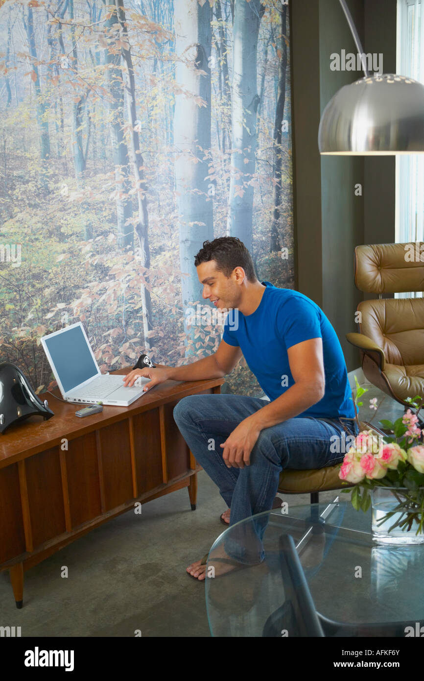Side profile of a young man using a laptop Stock Photo - Alamy