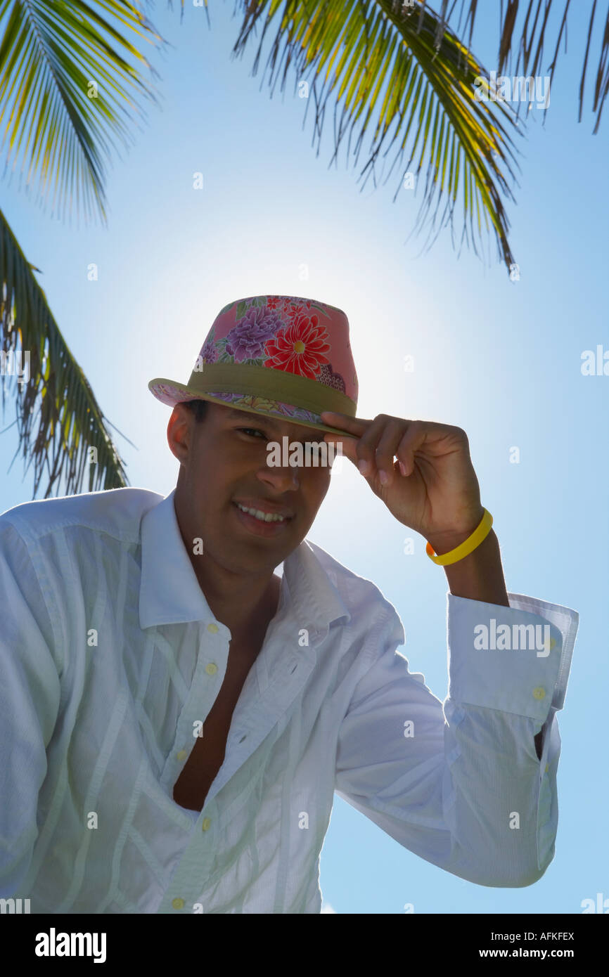 Portrait of a young man adjusting his hat and smiling Stock Photo - Alamy