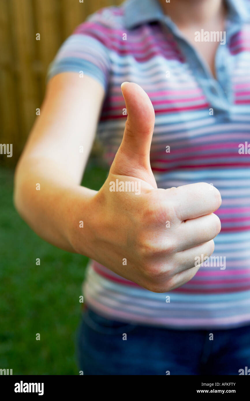 Mid section view of a woman making a thumbs up sign Stock Photo - Alamy