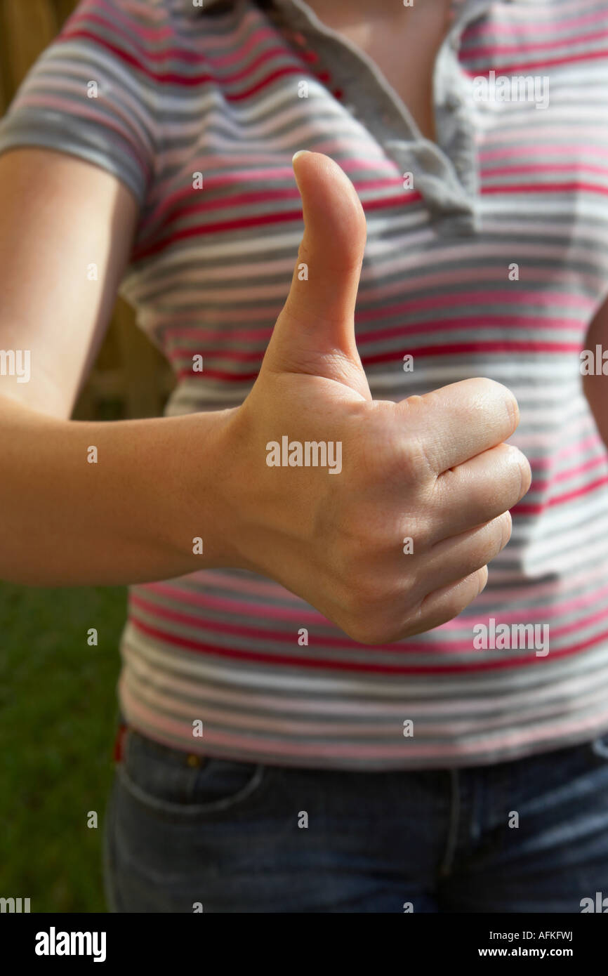 Mid section view of a woman making a thumbs up sign Stock Photo - Alamy
