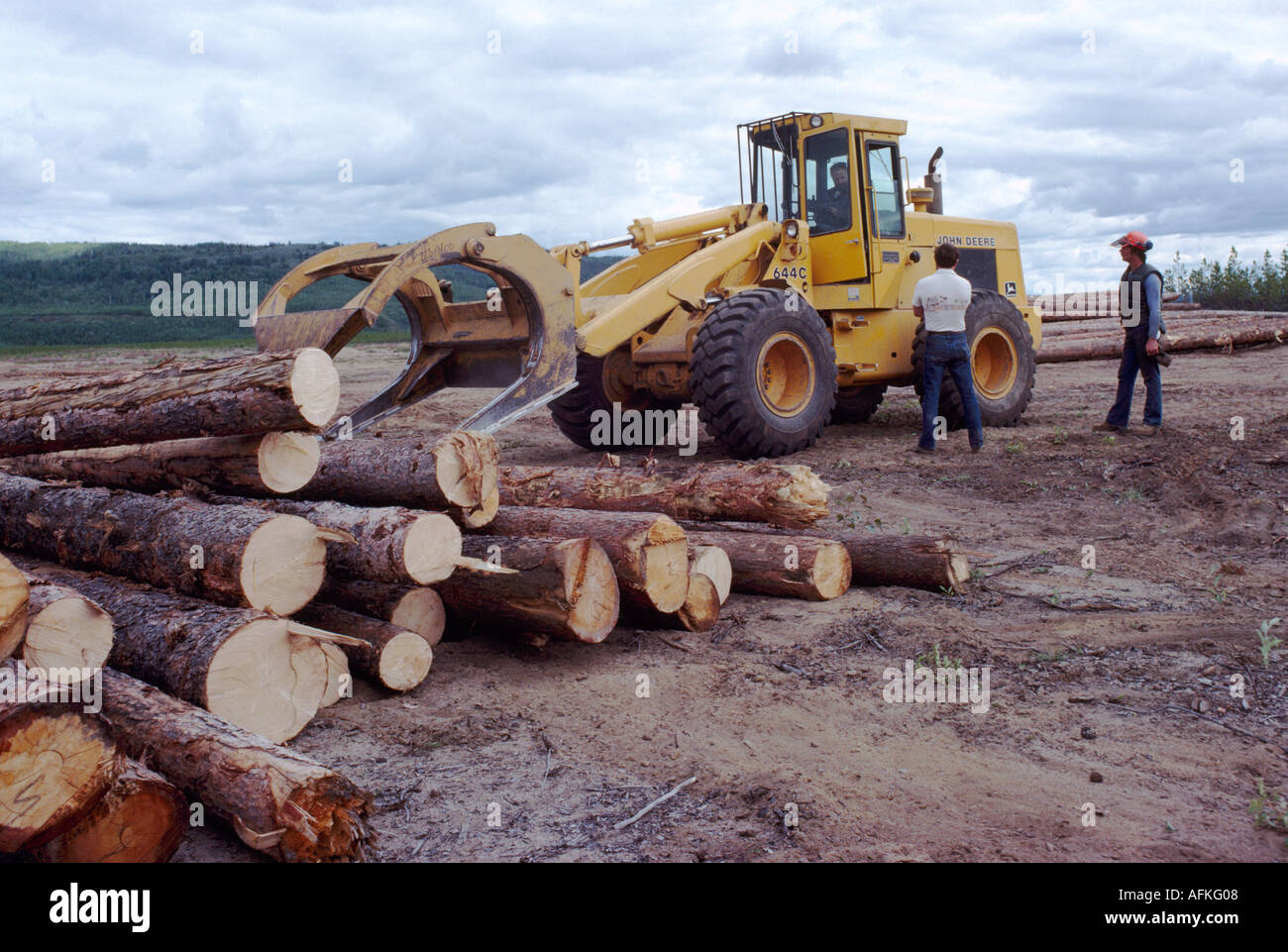 A Front-end Loader sorting Logs near Port Renfrew on Vancouver Island ...