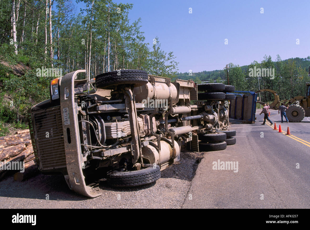 A Highway Accident with Over-turned Logging Truck and Spilled Load of ...