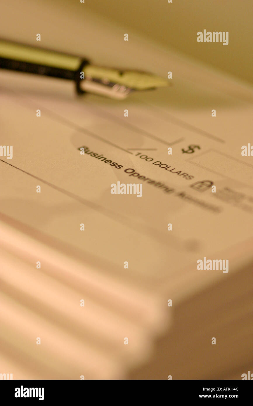 Fountain pen on business cheque book stack Stock Photo - Alamy