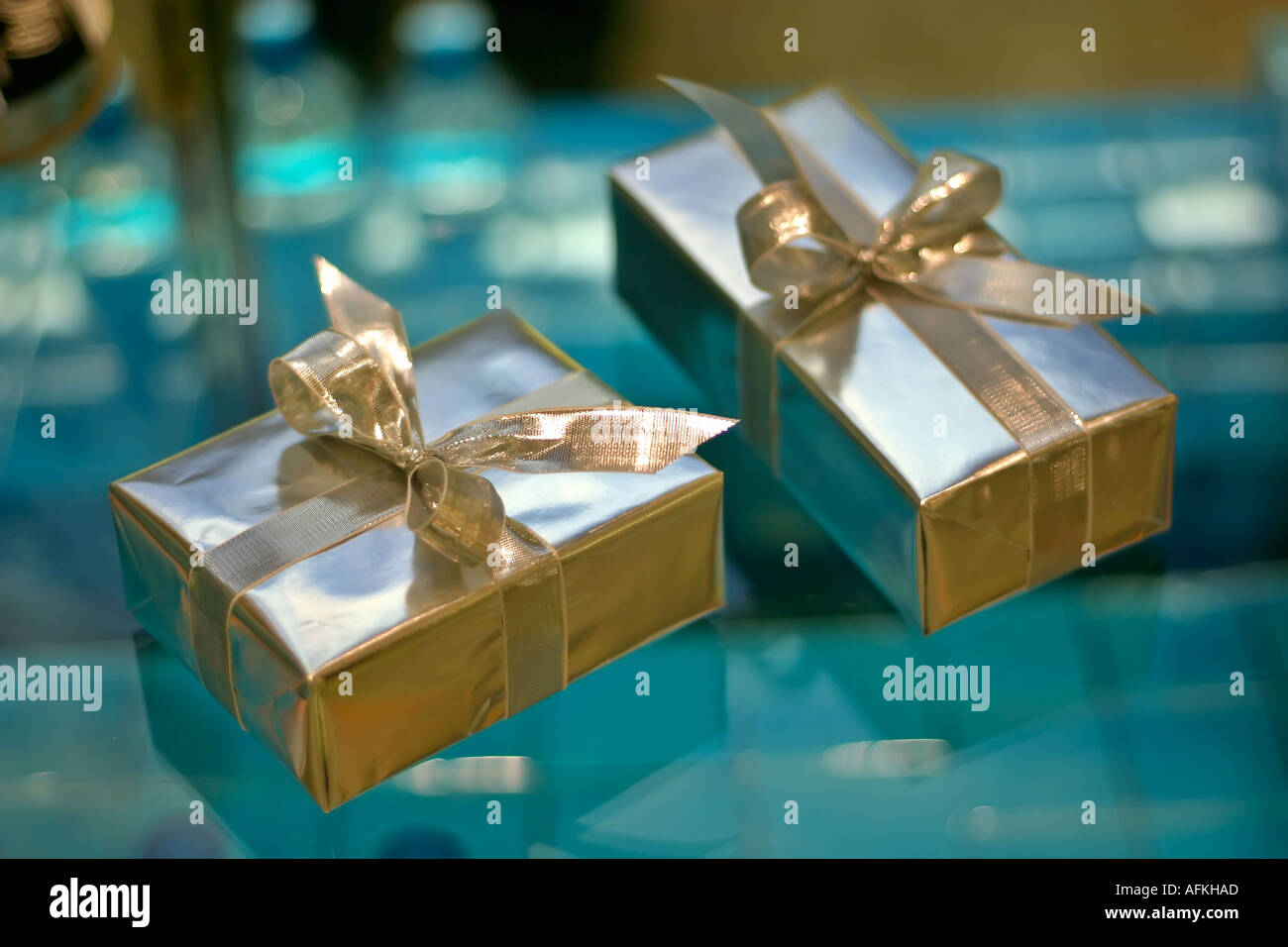 Silver gift boxes on blue Stock Photo - Alamy