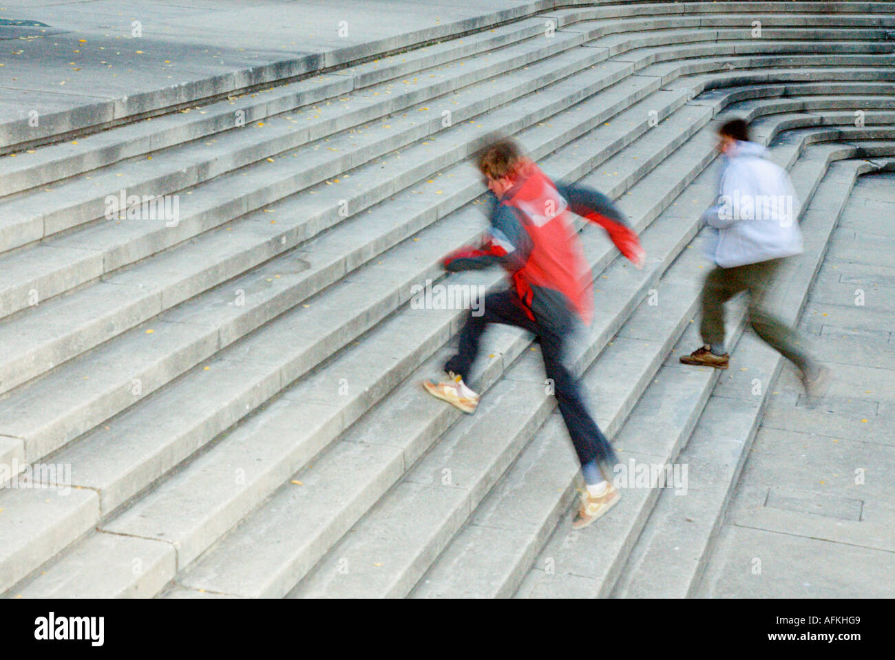 Teenage boys running up steps near Marcus Center for the Performing ...
