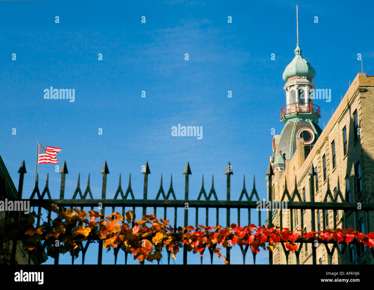 Old Schlitz Brewery stock house building with fence and American flag ...