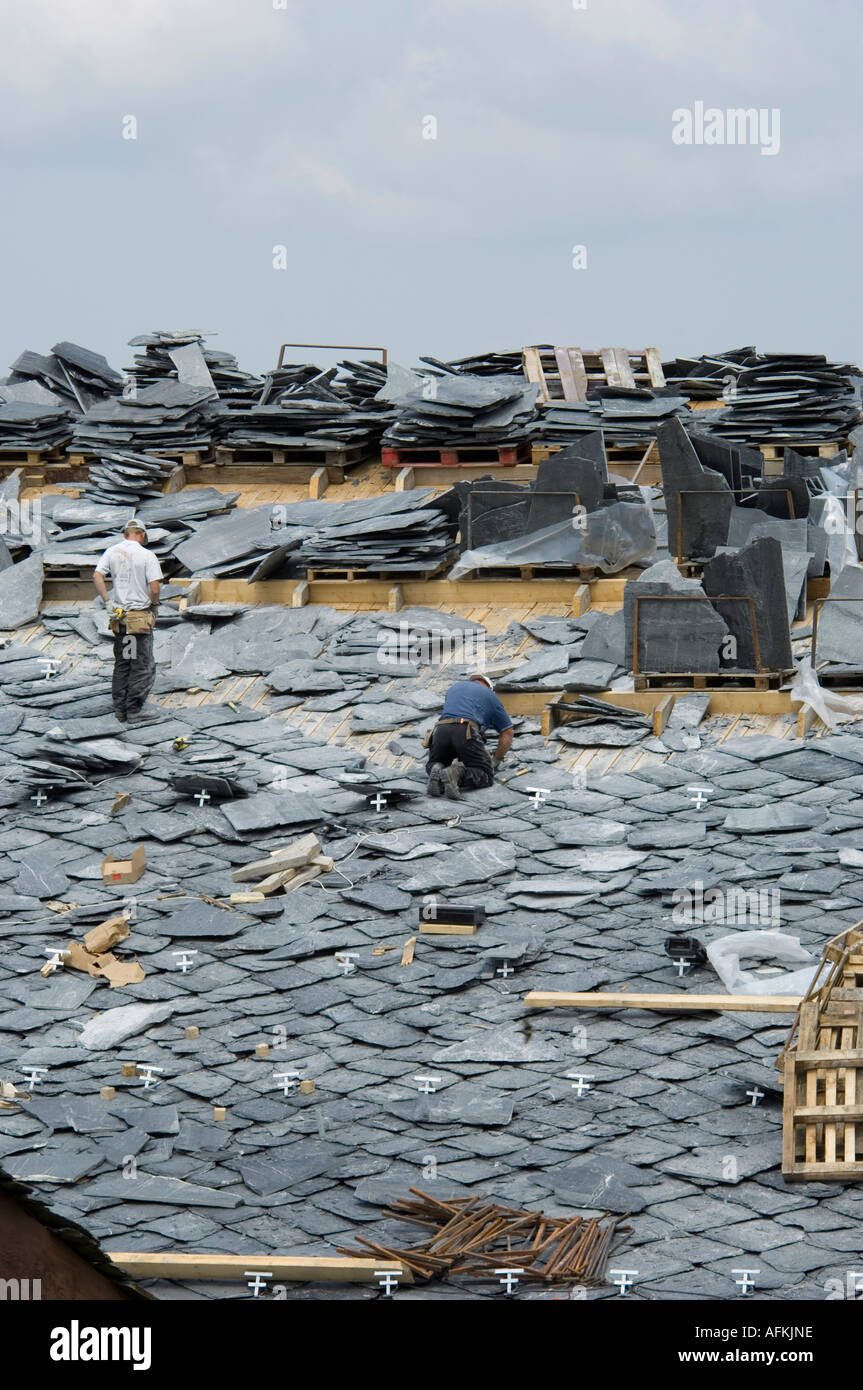 Laying a traditional slate roof on a building in the french alps Stock ...