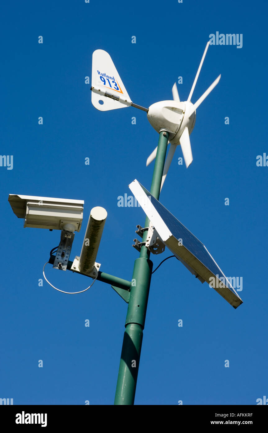 wind and solar powered CCTV camera on pole; against a clear blue ...