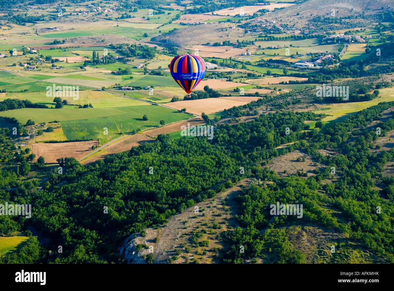 Hot air balloon flying over fields in Provence, Southern France Stock ...