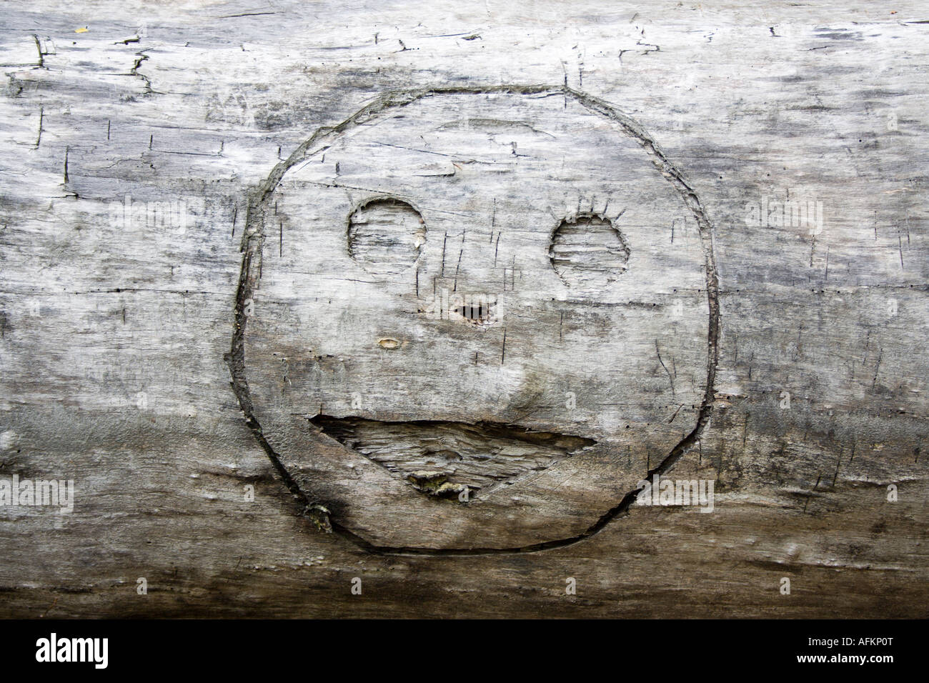 smile graven a long time ago in wood Stock Photo - Alamy