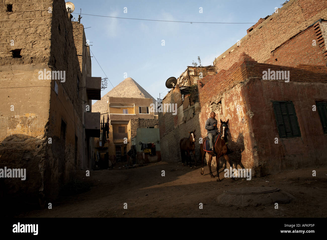Sitting in the shadow of the Pyramids, the suburb of Giza, Cairo, Egypt ...