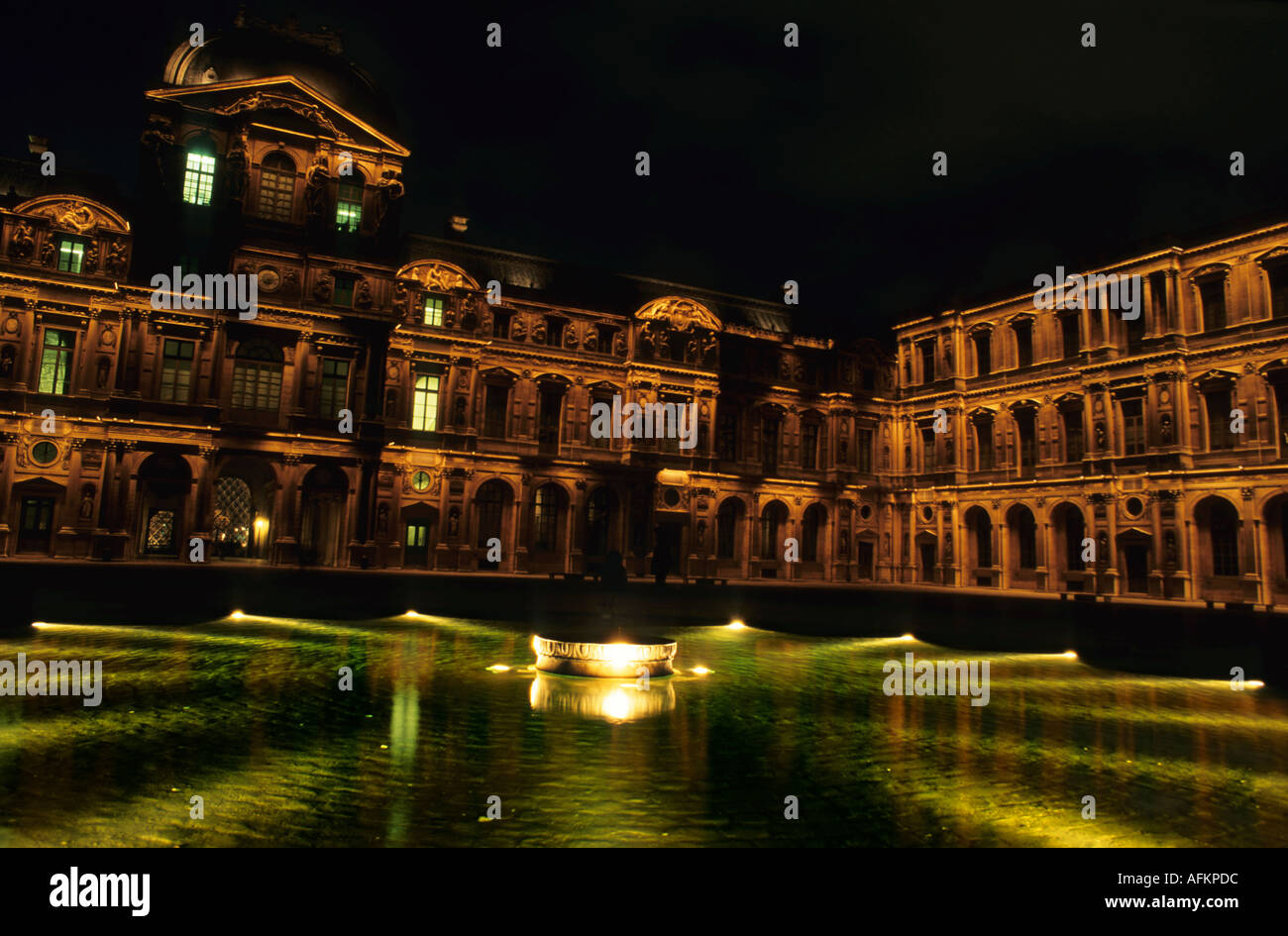 La Cour Carrée and the building of the Louvre illuminated at night ...