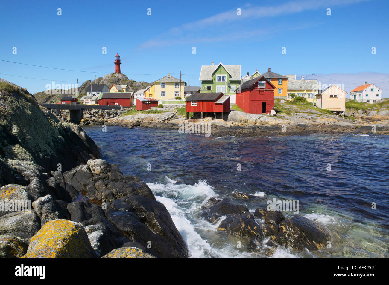 The Ona lighthouse on Onakalven above the fishing village of Ona Sandoy ...