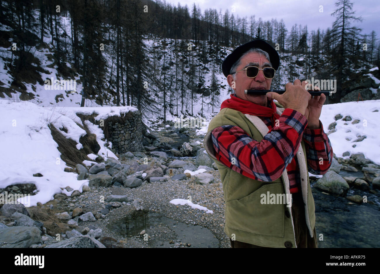 Man playing the fife in the clearing of a snowy forest, Gordolasque ...