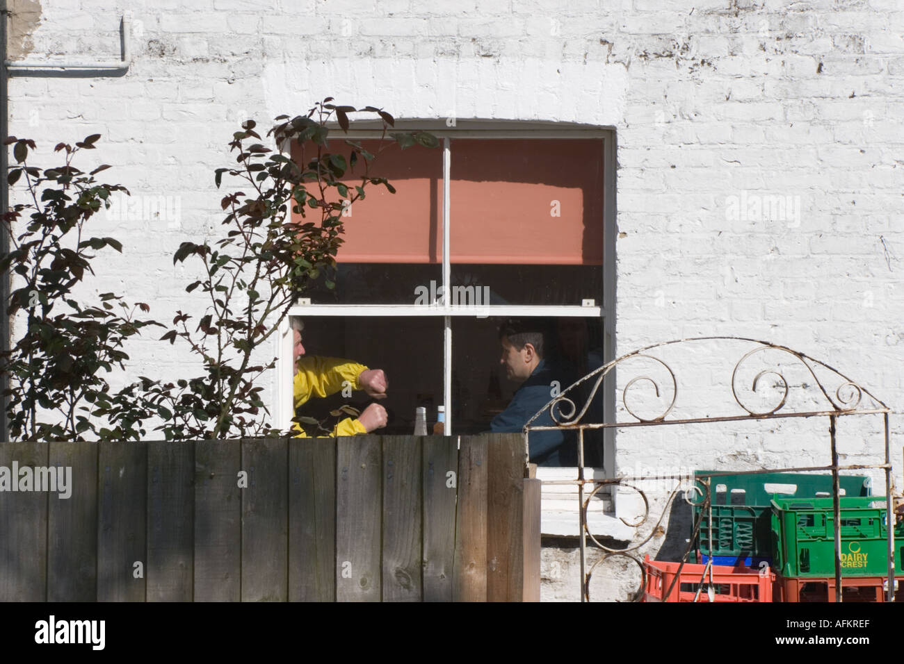 Two men talking in a cafe viewed from outside the window Stock Photo ...