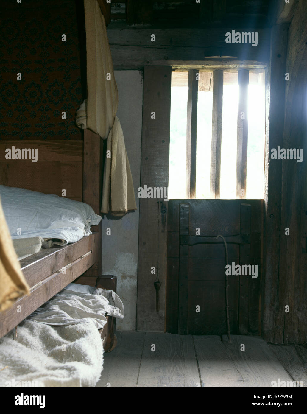Old wooden pull out beds in dilapidated bedroom Stock Photo - Alamy